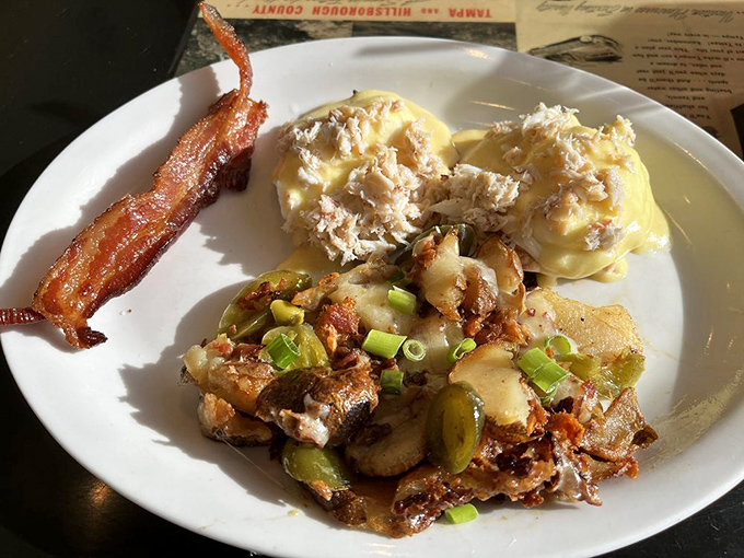 Eggs Benedict gets the coastal Florida treatment with lump crab meat, while those home fries are having their own little flavor party on the side.