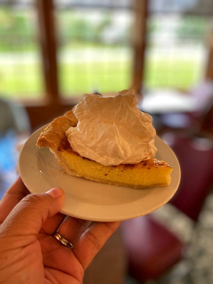 Custard pie topped with a cloud of whipped cream – the kind of dessert that makes you temporarily forget your name and contemplate moving to Amish country permanently.
