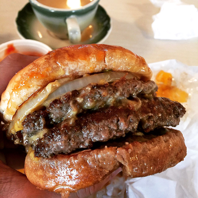 This isn't just a burger – it's edible history, with melted cheese cascading down a perfectly charred patty like lava from a delicious meat volcano.