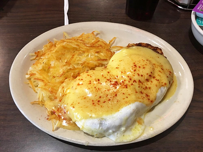 Hollandaise heaven! The Engine House's legendary Eggs Benedict arrives with perfectly crispy hashbrowns. That sprinkle of paprika isn't just for show—it's a flavor flare.