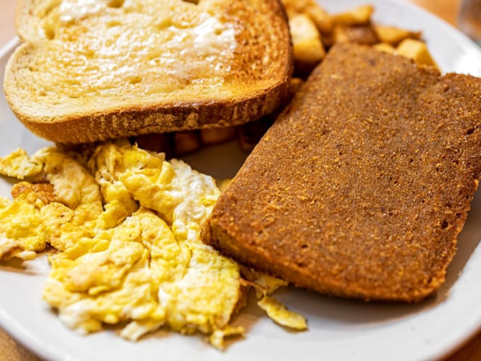 Simple perfection on a plate: fluffy scrambled eggs, crispy scrapple, and golden toast—the holy trinity of Pennsylvania breakfast done exactly right.