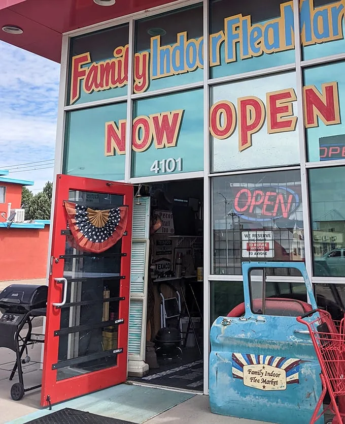 That patriotic bunting and weathered blue truck? Not decorations—they're the unofficial welcoming committee to this wonderland of finds.