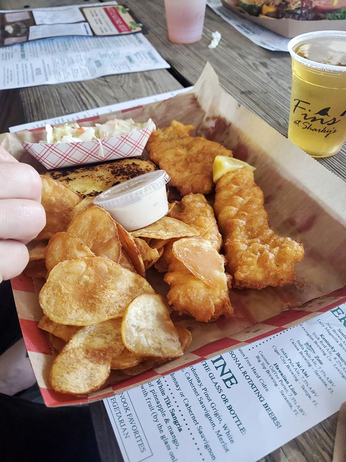 Golden-battered fish that shatters with each bite, paired with house-made chips. This isn't just fish and chips—it's edible Florida sunshine on a paper tray.