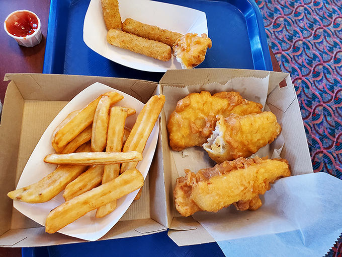 Golden armor of batter protecting flaky white fish alongside thick-cut chips—this isn't just fast food, it's a British tradition that found its perfect American ambassador.