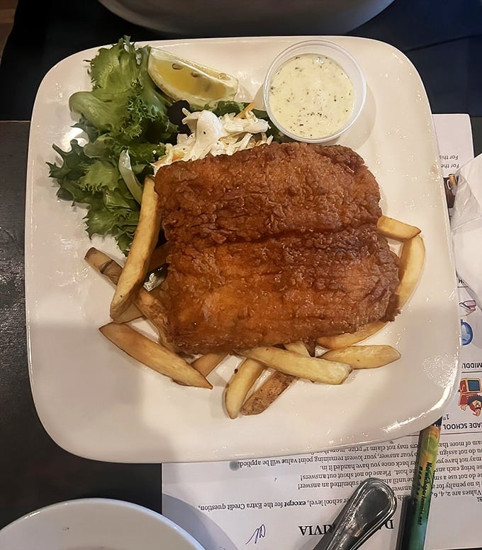 Golden-battered fish resting on a bed of hand-cut fries – this isn't just fish and chips, it's Neptune's treasure served with a side of coastal perfection.