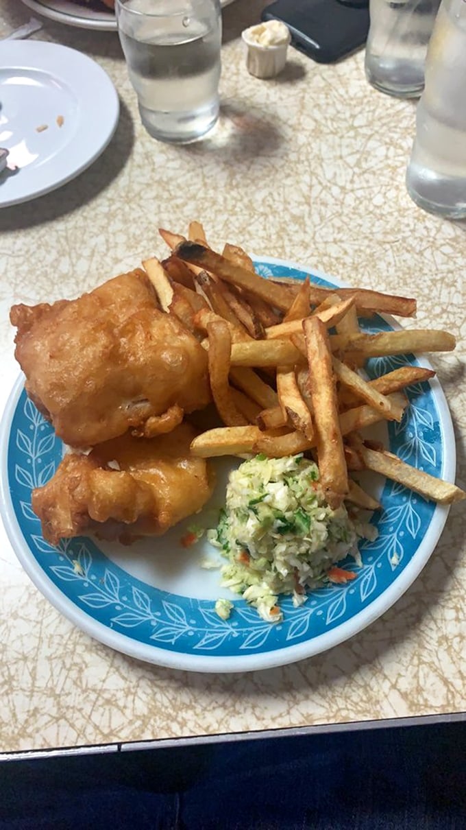 Golden-battered perfection on a blue plate special. That first satisfying crunch gives way to flaky fish heaven—a Detroit culinary ritual worth every calorie.