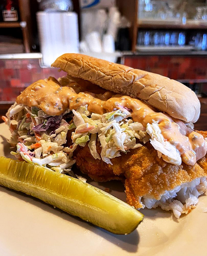 The legendary fish sandwich in all its glory—where crispy breaded cod, creamy coleslaw, and sauce create a holy trinity of flavor that's worth crossing state lines for.