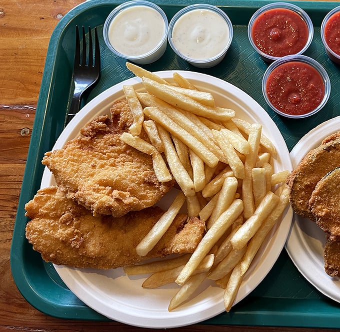 Golden-battered fish resting alongside perfectly crisp fries—proof that sometimes the simplest combinations are culinary perfection.