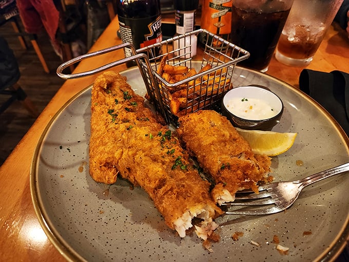 Golden-battered fish that shatters with each bite, served with a basket of fries that could make a potato proud.