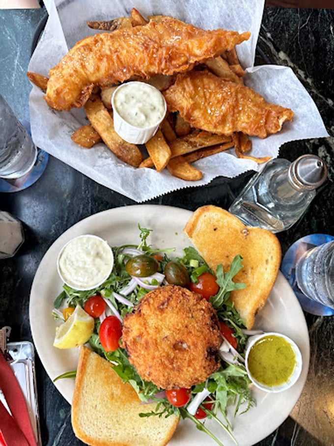 Golden-battered Wild Alaskan cod resting atop hand-cut chips—this isn't just dinner, it's edible architecture built on centuries of tradition.