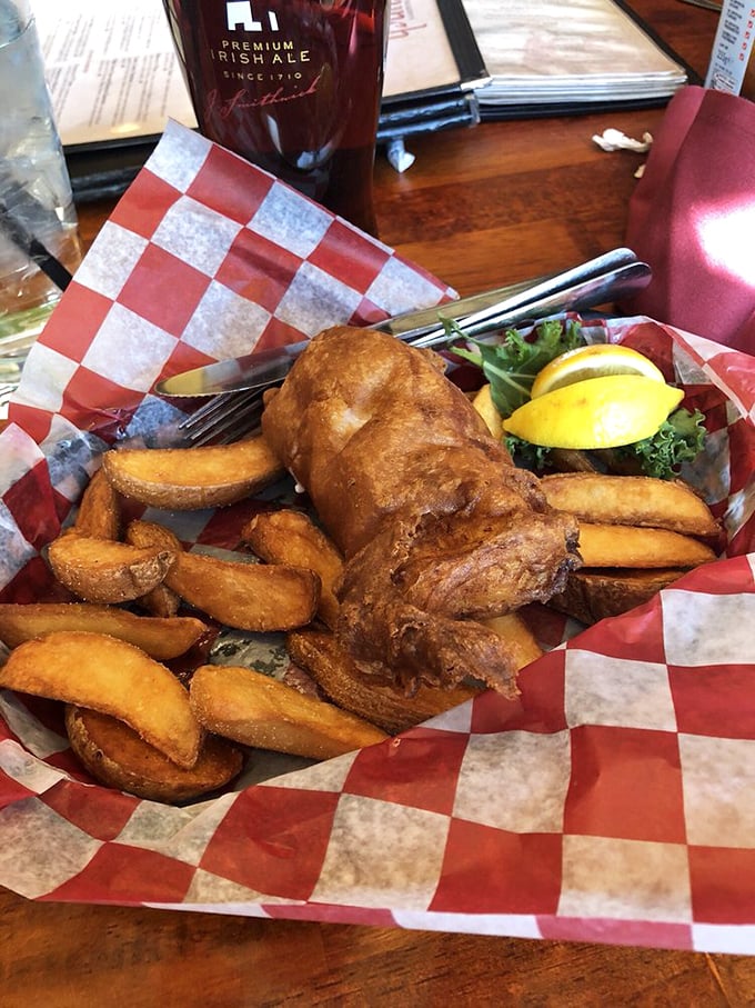 Golden-battered fish and chunky chips served in a red checkered basket—proof that simplicity, when done right, is the ultimate sophistication.