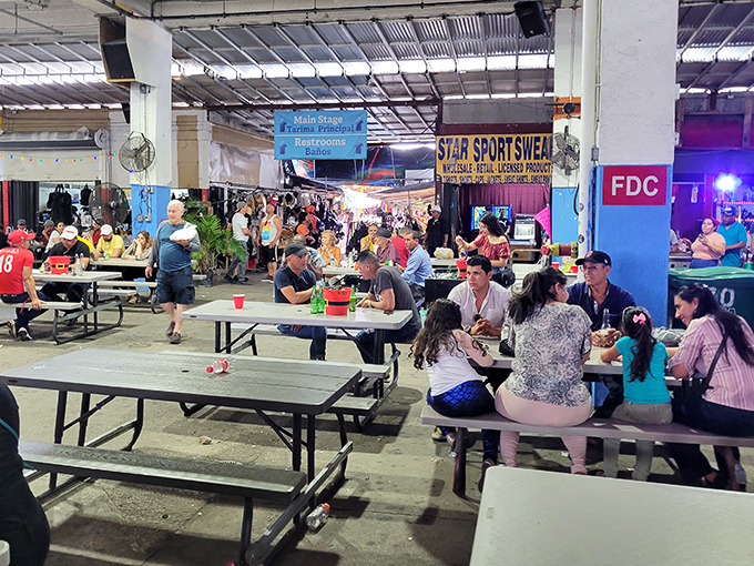 Communal dining at its most authentic—where strangers become temporary family over plates of food that tell stories of distant homelands.