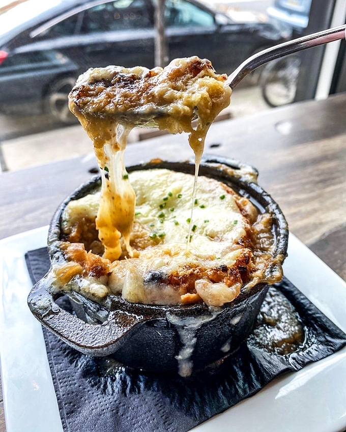 The French onion soup that dreams are made of. That cheese pull isn't just Instagram-worthy—it's a religious experience that transforms ordinary soup into extraordinary memories.