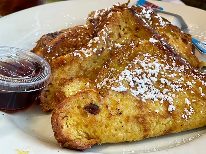 Challah French toast that's achieved celebrity status in my dreams. Crispy edges, custardy center, and enough powdered sugar to make your dentist wince.