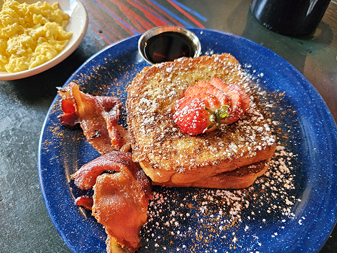 French toast that deserves its own fan club, dusted with powdered sugar and served with perfectly crisp bacon—breakfast doesn't get more photogenic than this.