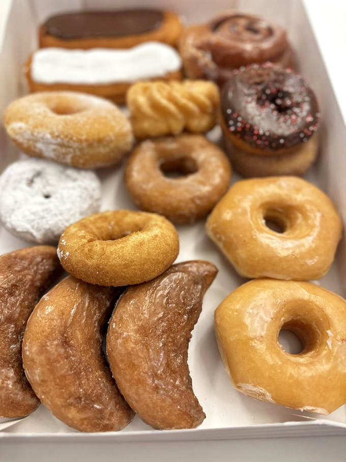 A box of pure dopamine – each donut promising the kind of happiness that not even the best therapist could provide.