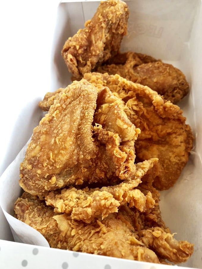 Golden-brown perfection in a takeout box. This chicken doesn't just speak to you, it sings a crunchy serenade to your soul.