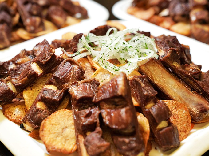These lamb ribs aren't just falling off the bone—they're practically jumping onto your fork. Served over crispy potatoes, it's comfort food elevated to art.