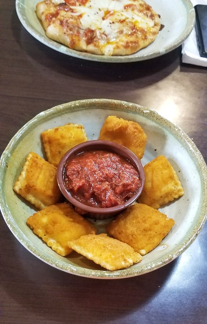 These golden-fried ravioli squares aren't just appetizers – they're little pillows of happiness that make waiting for your pizza an event rather than a chore.