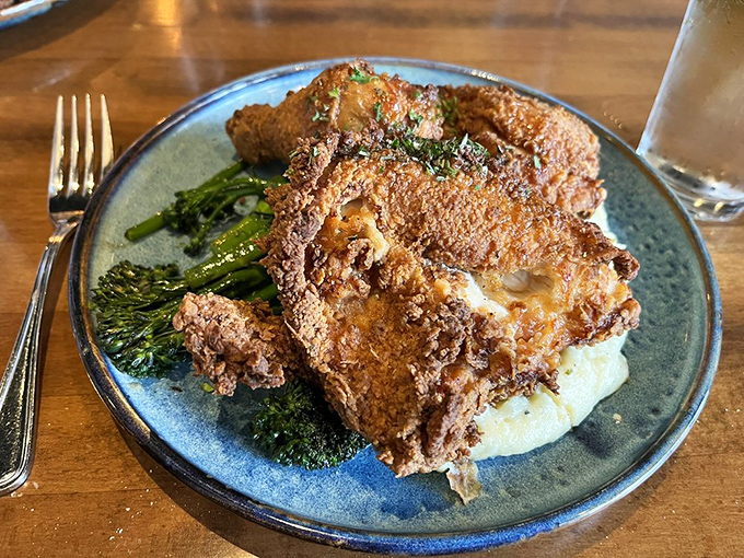Golden, crackling perfection atop a cloud of mashed potatoes. This fried chicken doesn't just speak to your soul—it sings a full gospel choir.