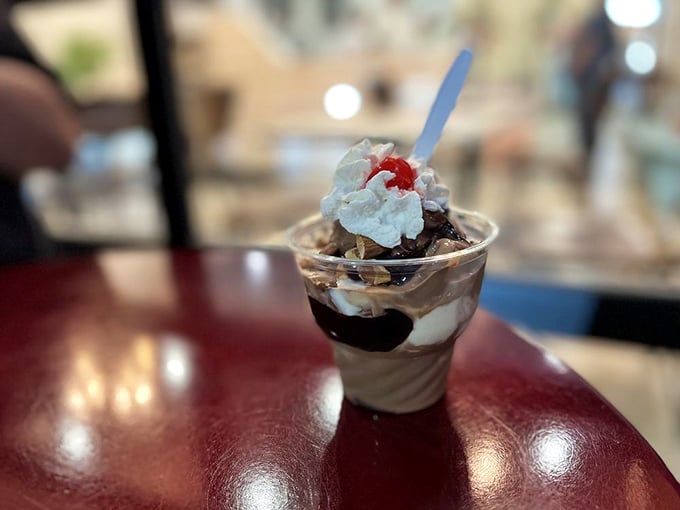 Layer upon layer of creamy custard, chocolate sauce, and whipped cream. This isn't just dessert—it's architecture with a cherry on top.