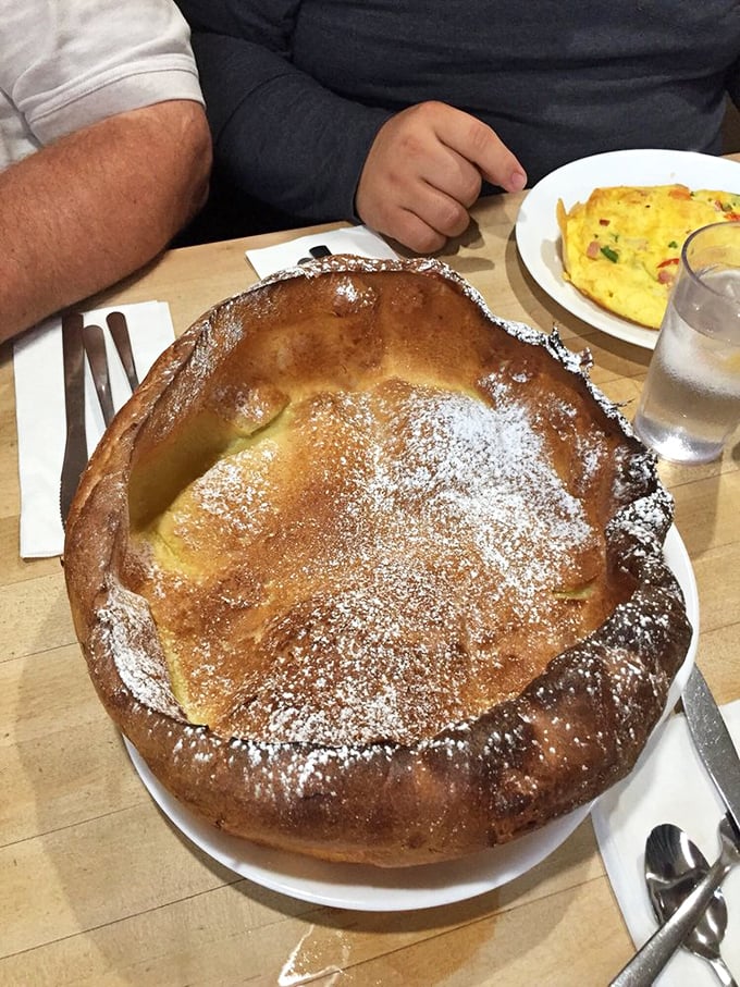 The German Pancake rises like a soufflé, collapses like your willpower, and tastes like breakfast nirvana dusted with powdered sugar.