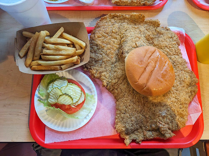 The legendary tenderloin in its natural habitat – a sandwich so massive it makes the plate look like a coaster. Bun for scale!