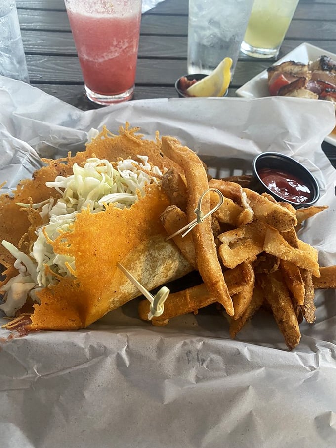 Golden-fried perfection nestled in a basket with crispy fries – this grouper taco delivers Florida's signature fish with a crunch that echoes through paradise.