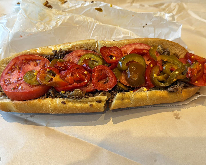 This isn't just lunch—it's an Italian beef masterpiece with vibrant tomatoes and peppers creating a harmony of flavors that sings with every bite.