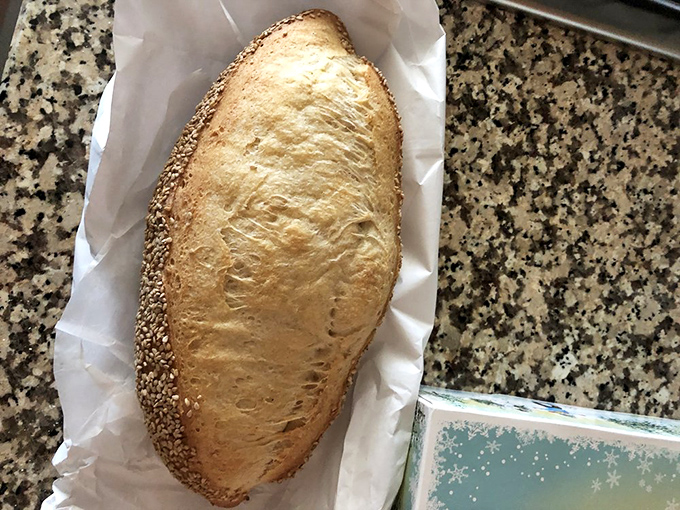 This sesame-crusted Italian roll isn't just bread—it's the foundation of civilization, wrapped in paper like the gift it truly is.