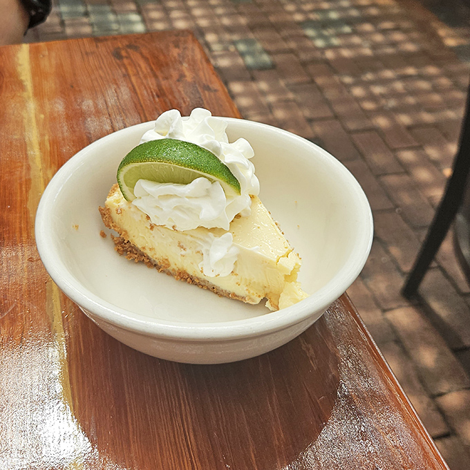 The legendary Key lime pie arrives like Florida sunshine on a plate—tart, sweet, and topped with a lime slice that's not just for show.