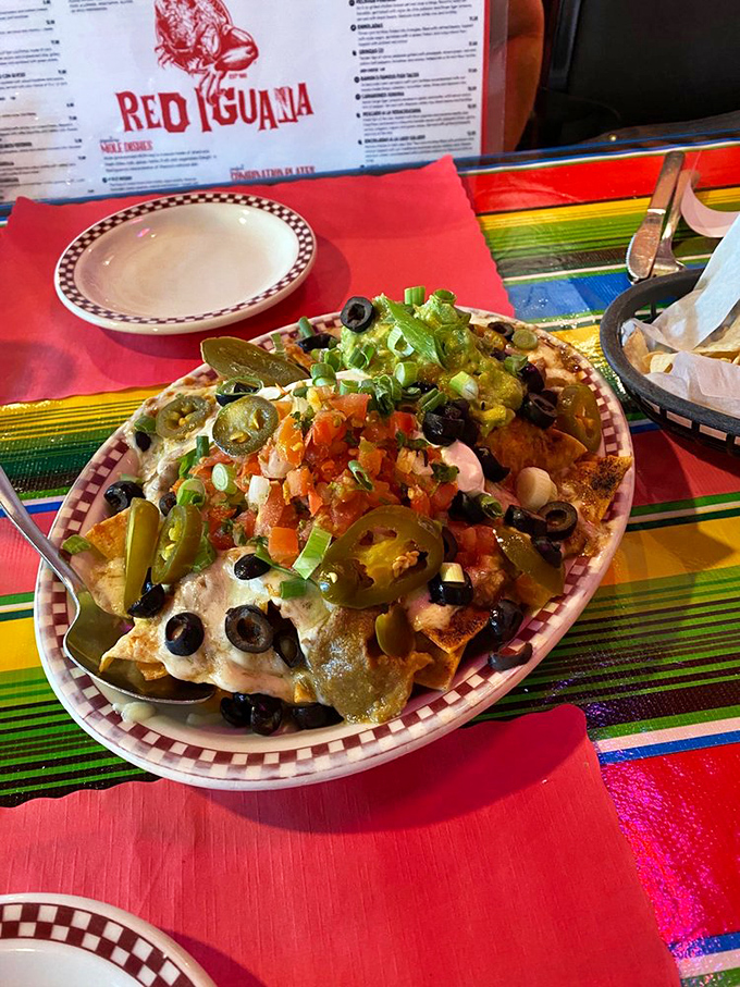These nachos aren't just loaded – they're having an existential crisis about whether they're still nachos or have evolved into something far more magnificent.