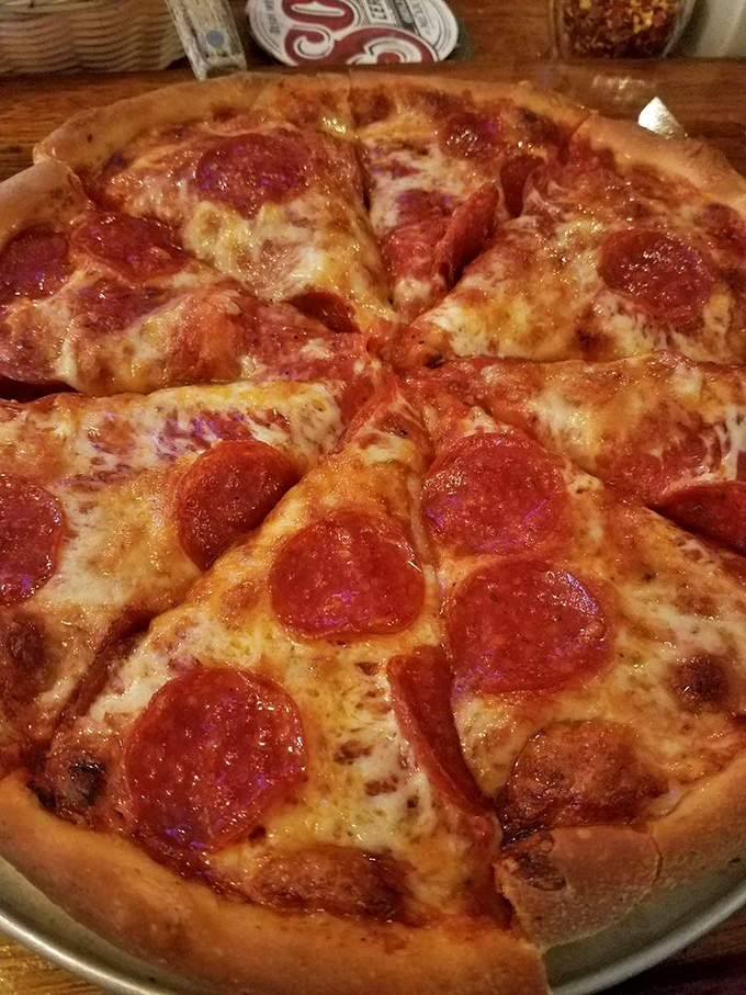 Pizza perfection doesn't need fancy words – those curled-edge pepperoni cups collecting pools of savory oil tell the whole delicious story.