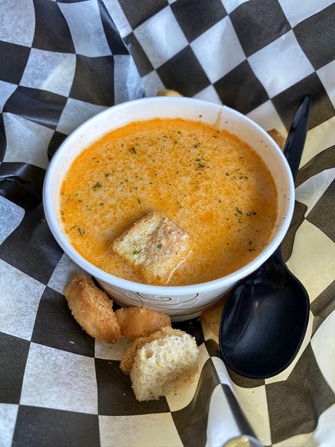 Liquid gold in a paper cup. This lobster bisque doesn't just warm your stomach—it hugs your soul with creamy, briny perfection.
