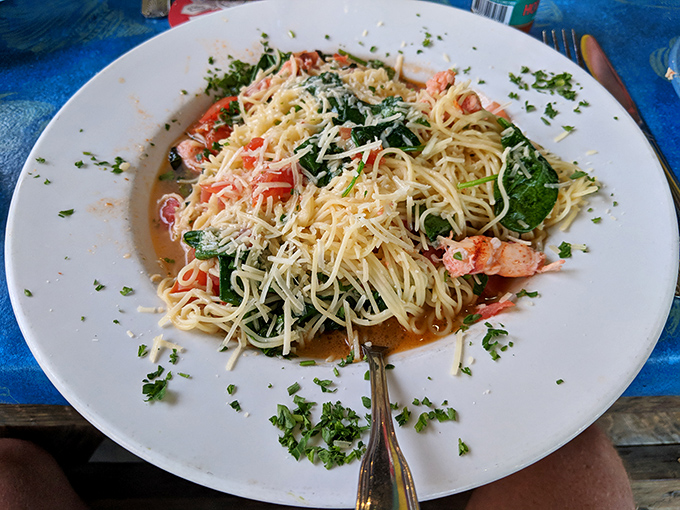 The lobster pasta arrives like a celebrity—chunks of Maine lobster mingling with spinach and tomatoes in a white wine butter sauce that deserves its own ZIP code.