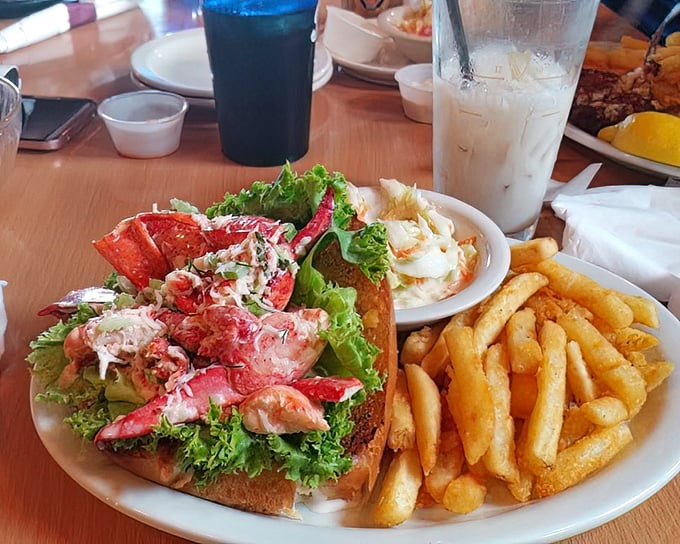 The legendary lobster roll in its natural habitat—surrounded by golden fries and anticipation. Maine might be calling to complain about this landlocked masterpiece stealing its thunder.