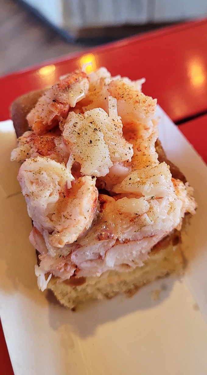 Chunks of sweet Maine lobster meat, perfectly seasoned and piled high. This isn't just a sandwich—it's edible evidence that sometimes simplicity truly is perfection.