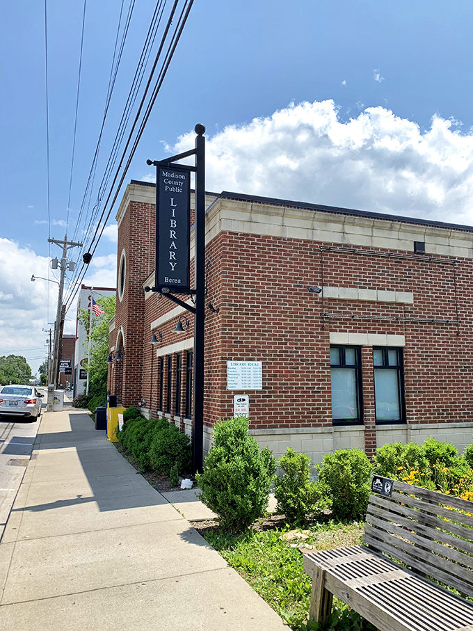 The Madison County Public Library stands as Berea's knowledge hub, its brick facade and welcoming bench inviting visitors to slow down and savor a good book.