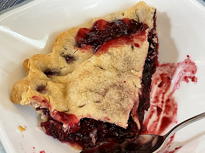 Behold the star attraction: marionberry pie with a perfectly flaky crust. That deep purple filling isn't just dessert—it's an Oregon tradition served one slice at a time.