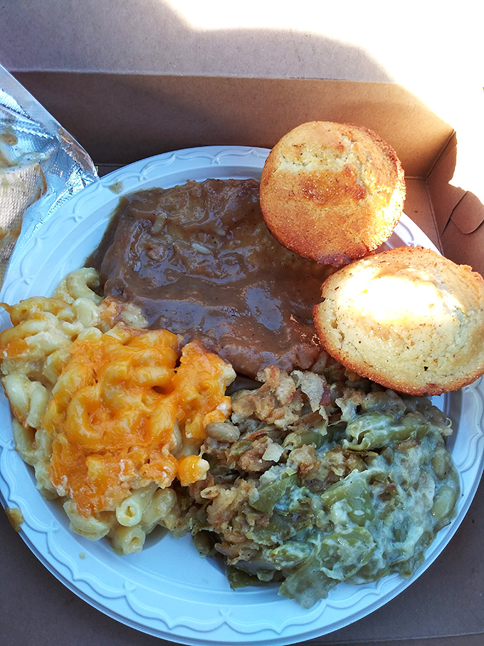 This isn't just meatloaf—it's a Southern symphony on a plate, where mac and cheese plays backup to the star attraction, and those cornbread muffins deserve their own standing ovation.