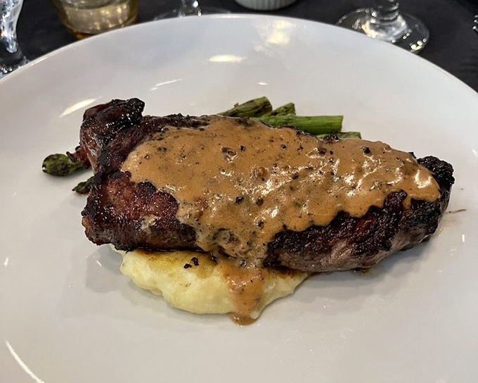 This NY Strip isn't just dinner—it's a masterclass in steak preparation, complete with a peppercorn sauce that could make you forget your own name.