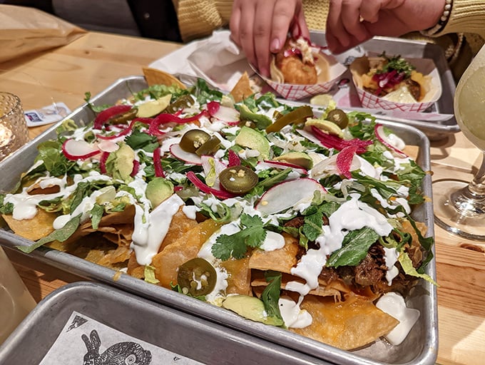 These aren't your average ballpark nachos. Vibrant jalapeños, pickled radishes, and creamy drizzles transform tortilla chips into an edible work of art.