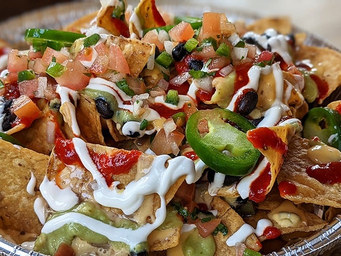 Nacho architecture at its finest. Every chip bears the perfect ratio of toppings—no sad, naked tortillas lurking at the edges of this masterpiece.