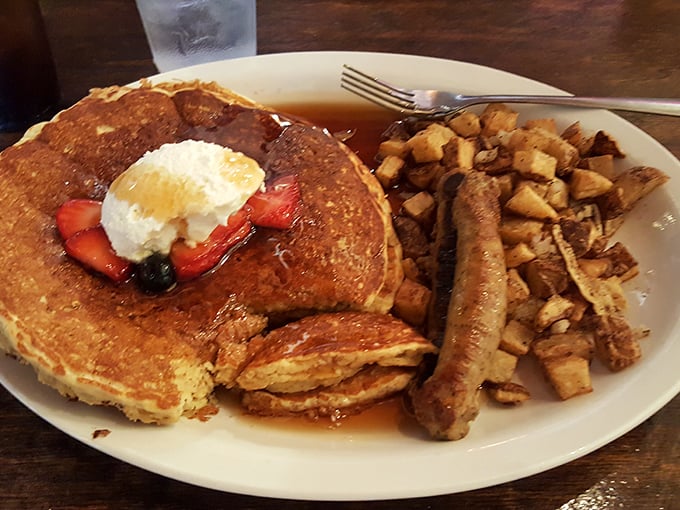 Golden pancakes with a dollop of whipped cream and fresh berries—the breakfast equivalent of hitting the lottery. Those home fries aren't playing second fiddle.