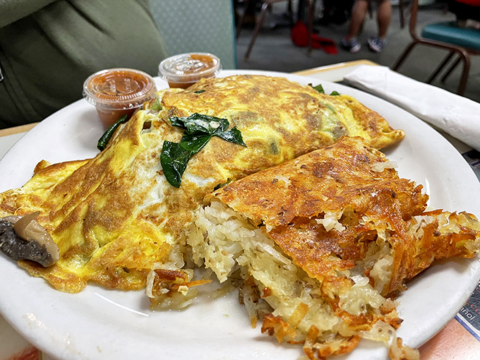 This veggie omelet isn't trying to win beauty contests – it's too busy delivering flavor bombs alongside hash browns that achieved the golden-brown perfection we all attempt at home.