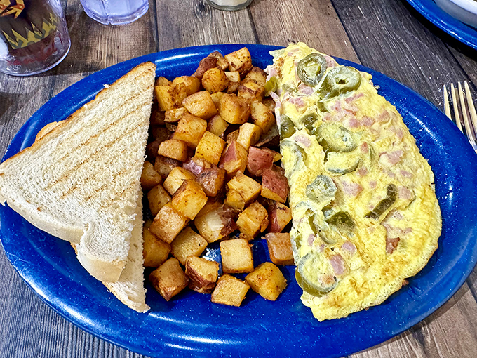 This isn't just any omelet—it's a masterclass in morning perfection, with home fries so perfectly seasoned they deserve their own fan club.