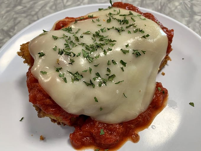 This isn't just melted cheese on chicken parmesan; it's a hug on a plate, complete with fresh herbs that say "someone in this kitchen cares."