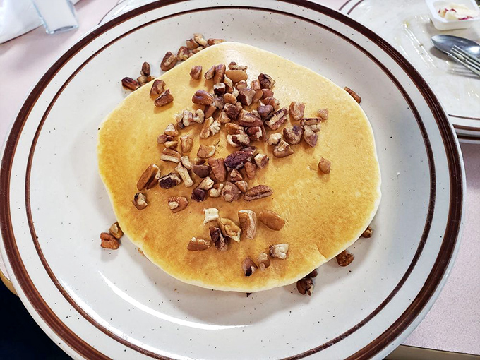 A golden pancake crowned with crunchy pecans—proof that sometimes the simplest pleasures are the most profound.