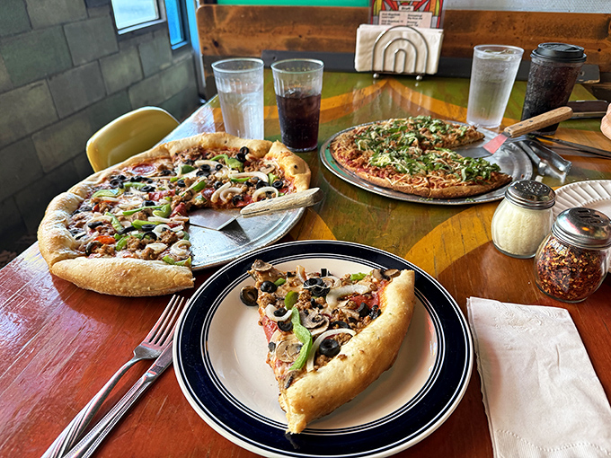 Pizza perfection in triplicate – the holy trinity of toppings, crust, and atmosphere converge on tables that have hosted thousands of "mmm" moments.