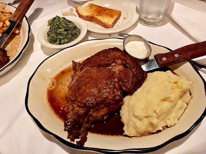 The prime rib arrives like a carnivore's dream—perfectly pink, swimming in savory au jus, with sides that know their supporting role.